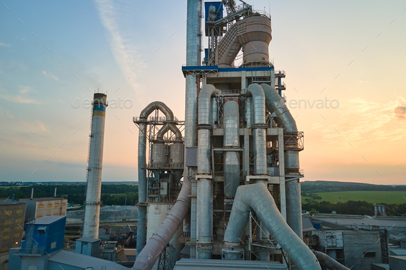 Cement plant with high factory structure and tower cranes at industrial ...