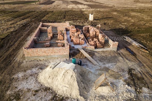 Aerial view of building site. Trenches dug in ground and filled with ...