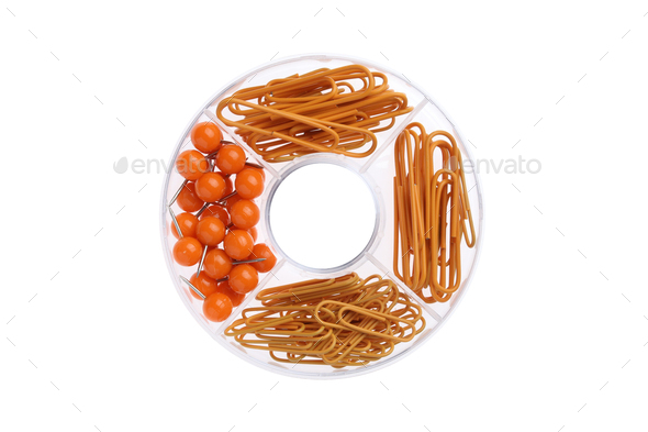 Paper clip dispenser, orange color pins and clips collection. Office ...