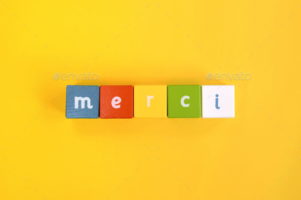 Merci - word made from colored wooden blocks. Painted cubes with ...