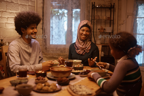 Happy Middle Eastern family enjoying in meal at dining table. Stock ...
