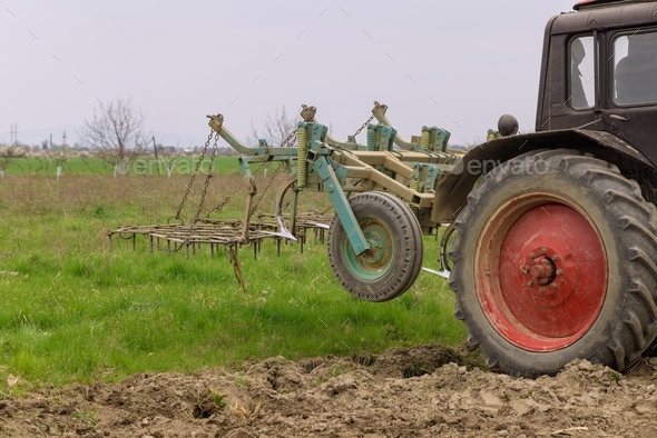 Tractor cultivates and milling soil on field. Farm work. Stock Photo by ...