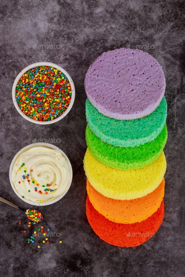 Cake assembly. layer cake with white icing and sprinkles. Stock Photo ...