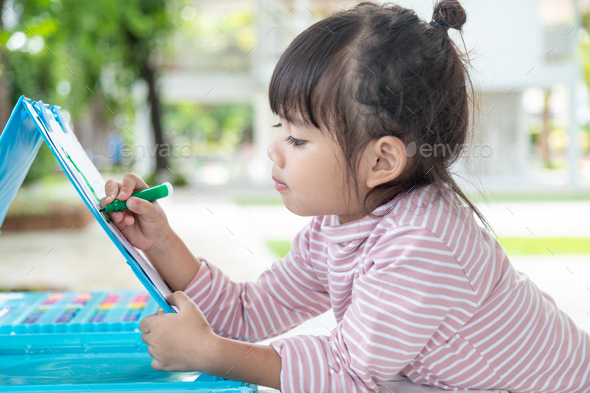 Little kids drawing with a colored pencil is a good activity for ...