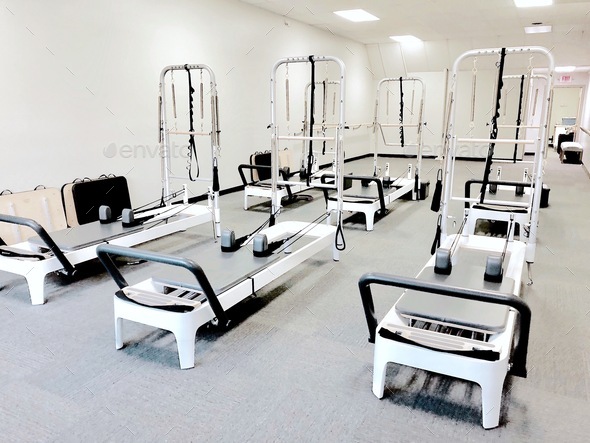 Pilates reformers in an empty exercise studio. Stock Photo by edemarco5