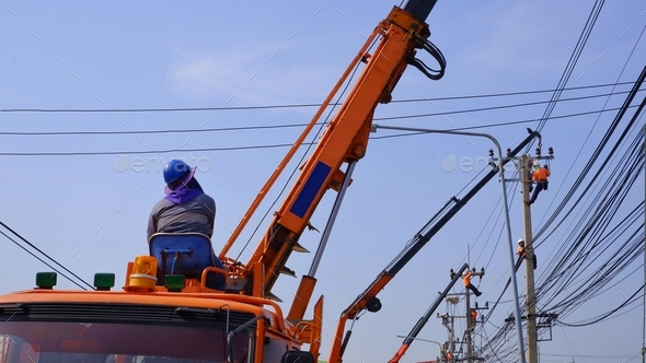 Electricians team with crane trucks installing electrical system on electric power poles Stock ...