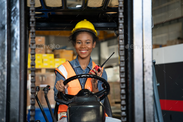 forklift operator in storage warehouse looking way during transport ...