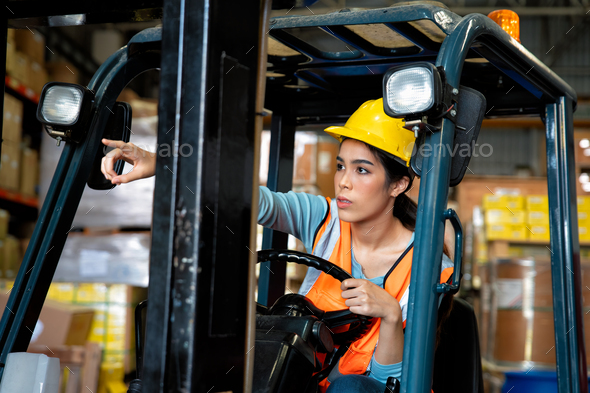forklift operator in storage warehouse looking way during transport ...