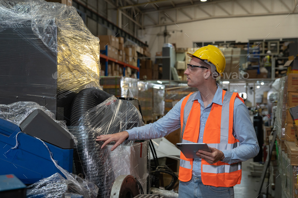 Engineer in warehouse use tablet check spare parts inventory check in ...