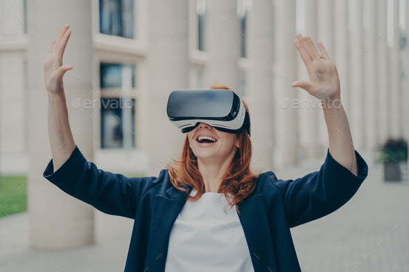 Impressed business woman testing virtual reality, using mobile VR ...