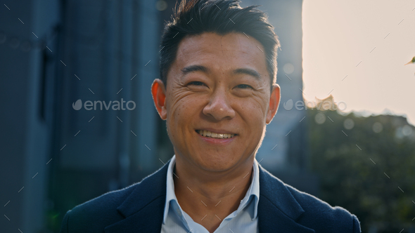 Outdoors portrait Asian 40s mature businessman smiling happy in city in ...