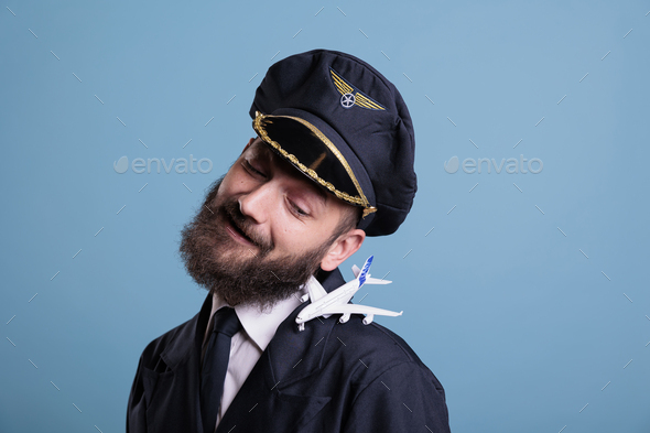 Smiling aviator in uniform with airplane model on shoulder Stock Photo ...