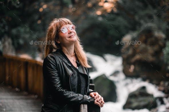 young caucasian girl contemplating the waterfalls from the viewpoint at ...