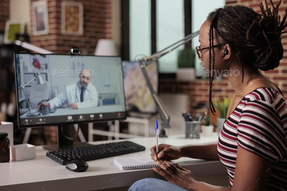 Patient talking with doctor on video call, taking notes Stock Photo by ...