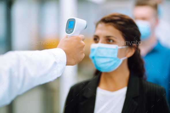 Office staff undergo temperature screening at the entrance. Business ...