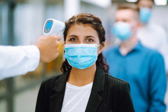 Office staff undergo temperature screening at the entrance. Business ...