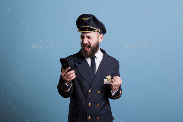 Happy smiling airplane pilot in uniform holding modern phone Stock ...