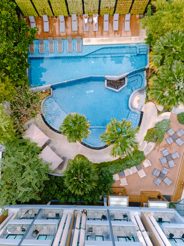 Drone view from above at swimming pool, couple men and women in ...