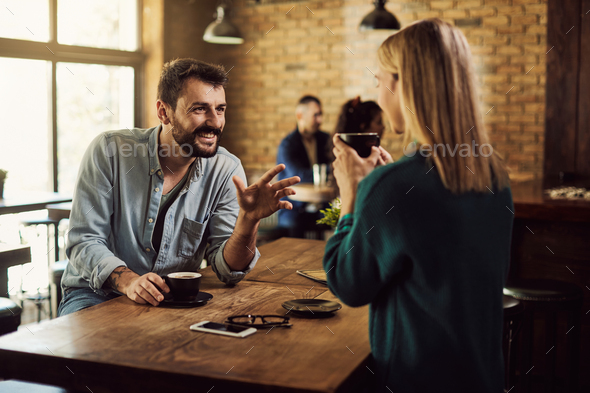 Happy couple talking while drinking coffee in a cafe. Stock Photo by ...
