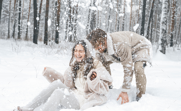 Romantic snow love story.Young couple guy girl lying,playing in snowy ...