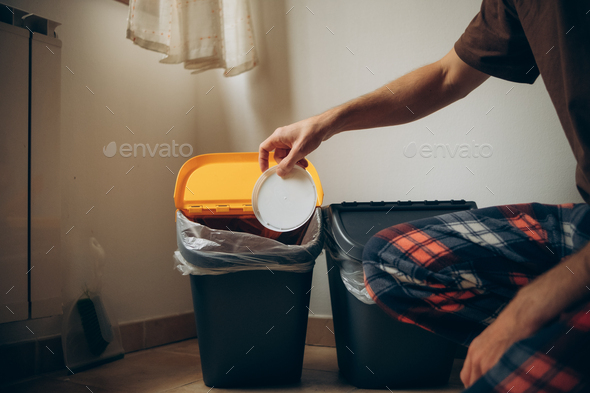 separate collection of garbage by the hands of a person throwing ...