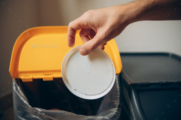 separate collection of garbage by the hands of a person throwing ...