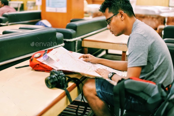 People looking maps Stock Photo by hakimihaslan | PhotoDune