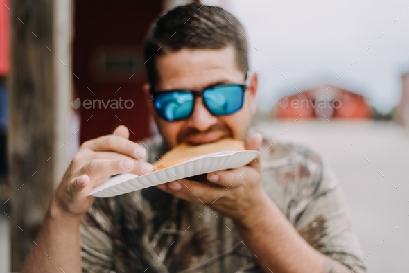 Man eating elephant ear Stock Photo by jamiesuephotography | PhotoDune