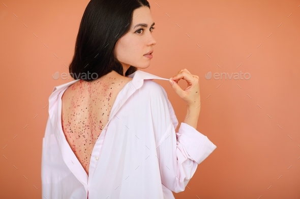 Back view of young female in white clothes revealing back with shiny ...