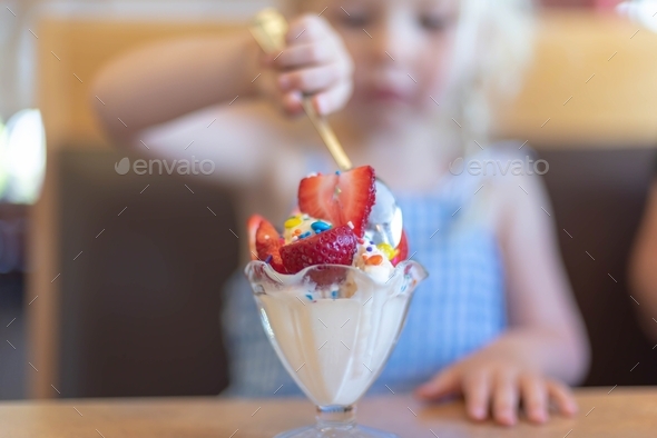 Child eating ice cream sundae Stock Photo by krisprahl | PhotoDune