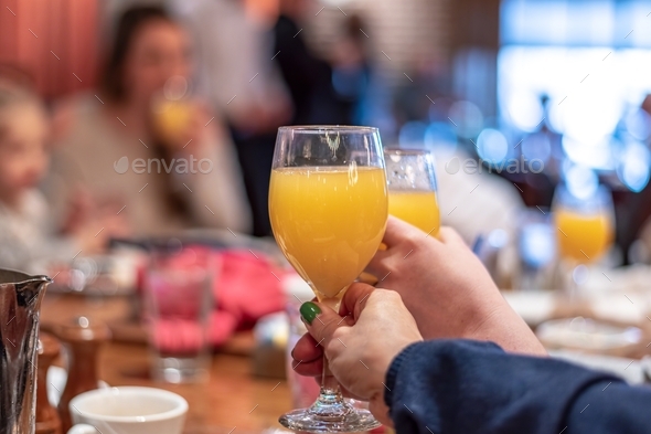 Toasting with mimosas at brunch Stock Photo by krisprahl | PhotoDune