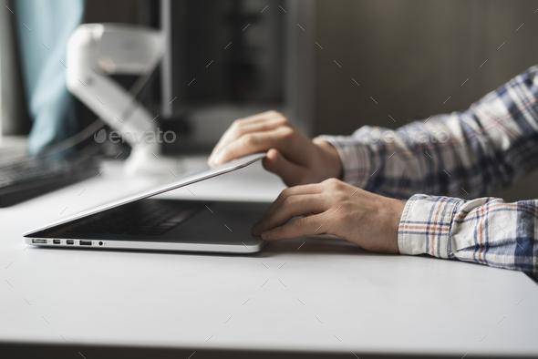 a person opens laptop computer to do some online work on project Stock ...