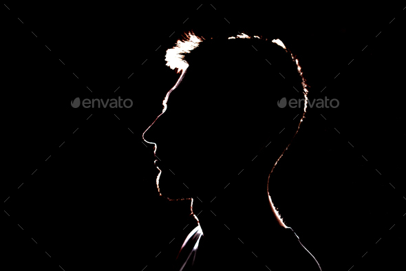 a dark backlight shadow silhouette of male person, incognito unknown ...