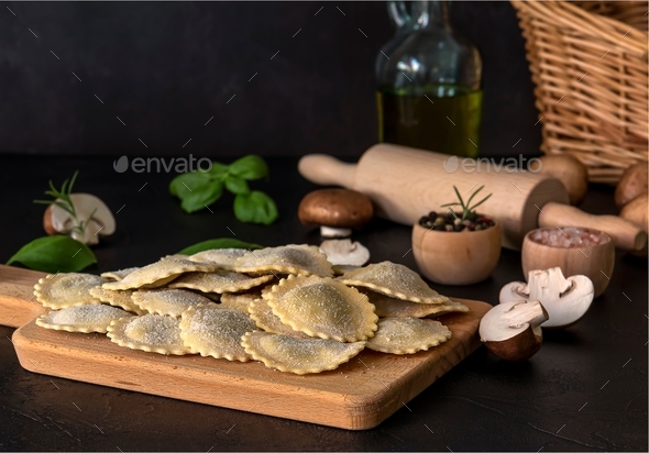 Fresh raw italian filled pasta ravioli or tortelli with mushrooms ...