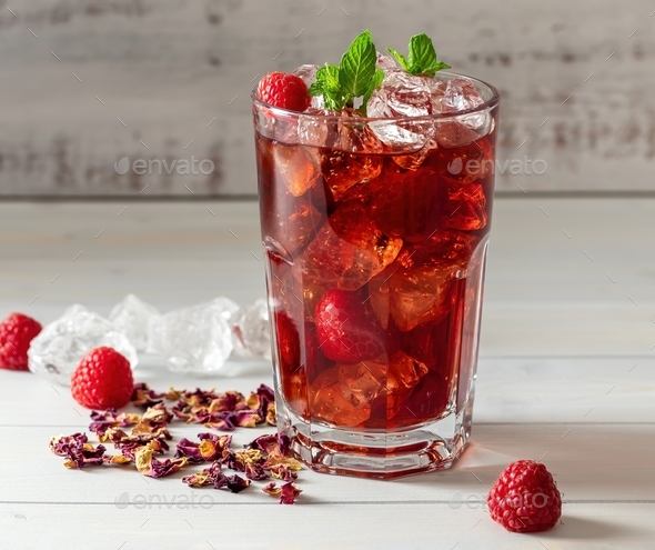 Cold sparkling hibiscus or karkade ice tea with lemon, mint, and ...