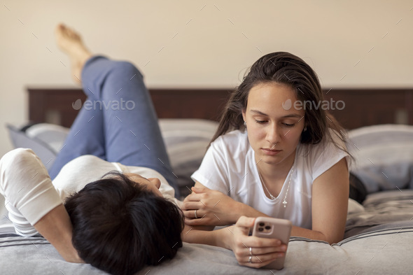 Family at home doing nothing on the bed mother and daughter using ...
