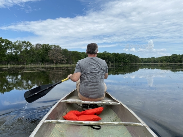 Back view of a man paddling a canoe on a hot summer day Stock Photo by ...