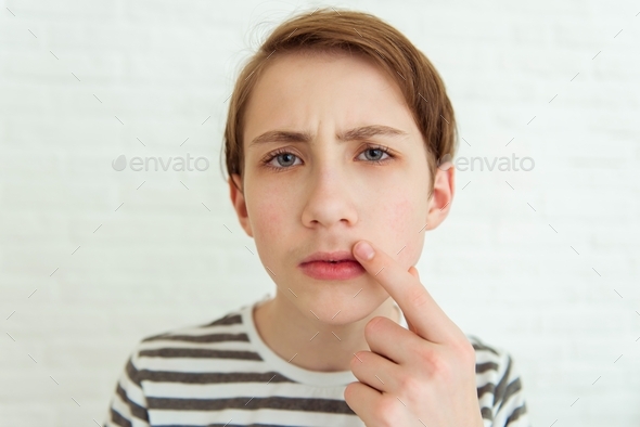 Teen boy looks at his first mustache in mirror, puberty period, early ...