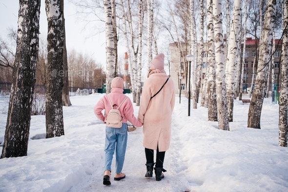 mom and daughter walk in the spring in the park holding hands Stock ...