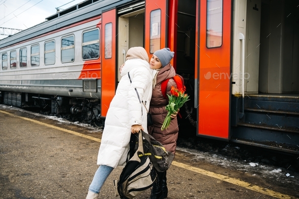 girls say goodbye hugging on the station platform Stock Photo by ...