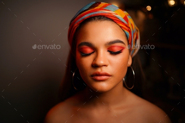 portrait of a beautiful swarthy girl with closed eyes dreams, orange ...
