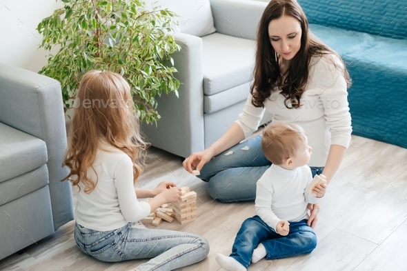 mom and kids playing django game on the floor Stock Photo by Repnitskaya