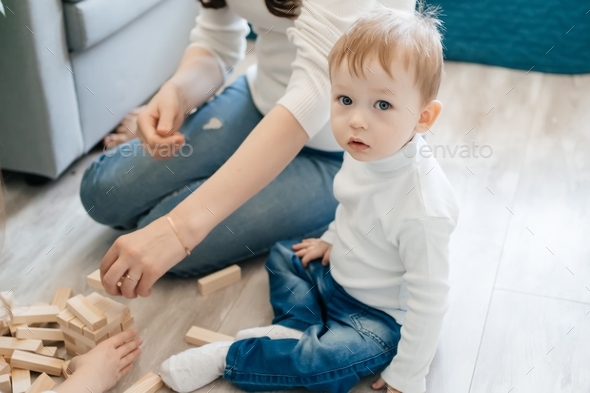 mom and kids playing django game on the floor Stock Photo by Repnitskaya