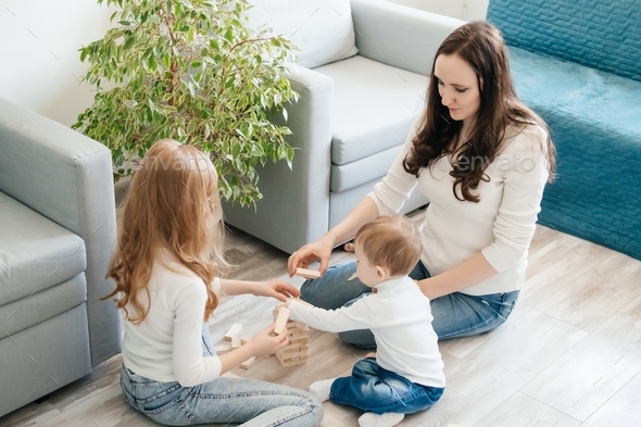 mom and kids playing django game on the floor Stock Photo by Repnitskaya