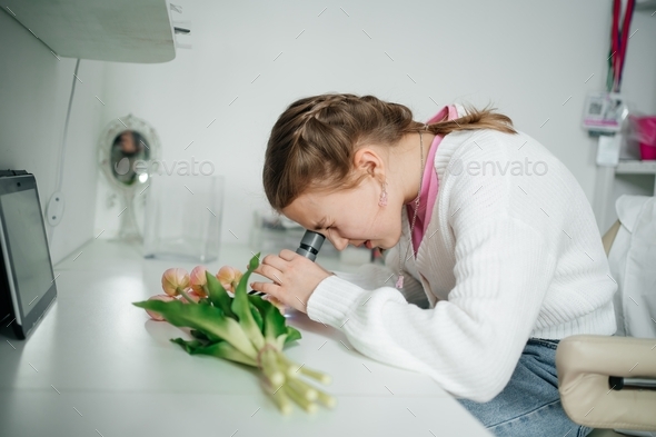 girl teenager uses electron microscope training Stock Photo by Repnitskaya