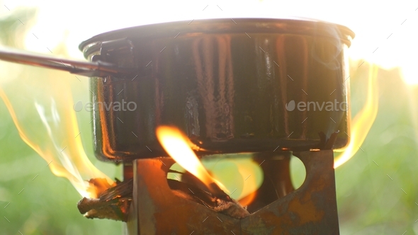 Boiling water on a camping stove Stock Photo by nikitavas | PhotoDune