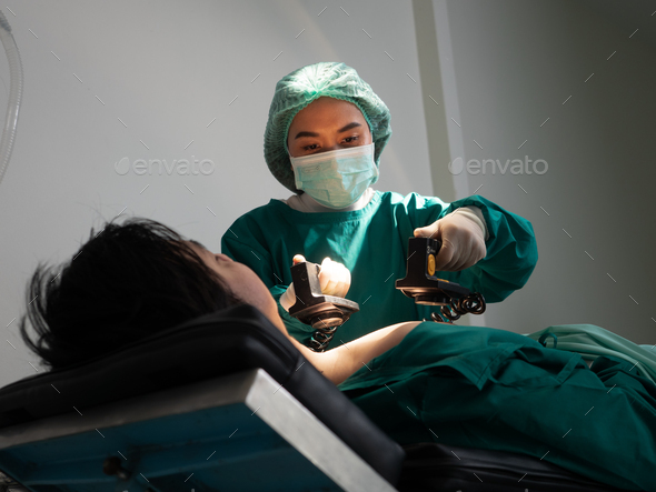 In hospital emergency room doctor shocking the heart use defibrillator ...