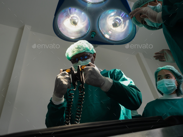 In hospital emergency room doctor shocking the heart use defibrillator ...