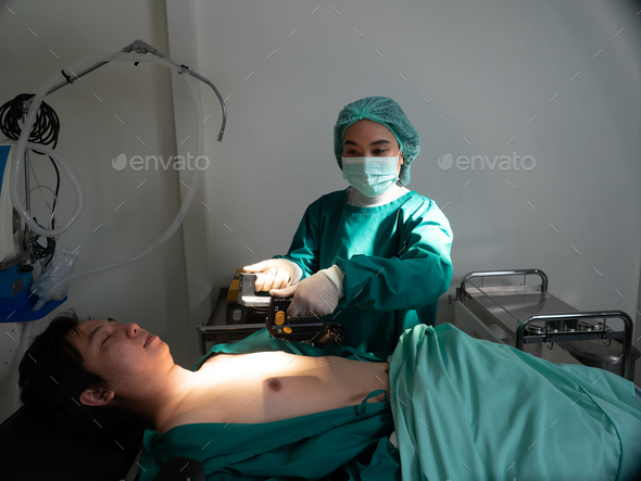 In hospital emergency room doctor shocking the heart use defibrillator ...