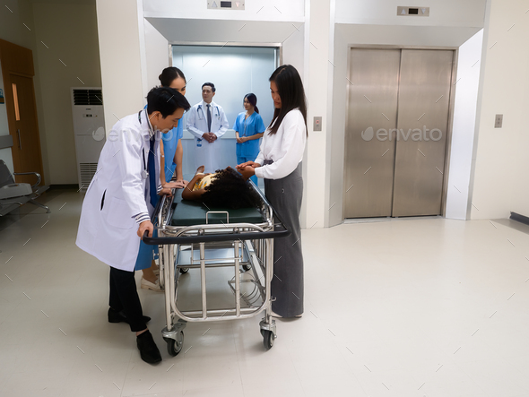 At hospital doctor and nurse looking at medical team in elevator ...